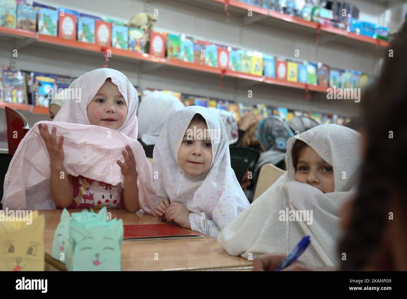Syrian girls prepare to read Azkar (reciting prayers) and Koran as part of a charity program for ...