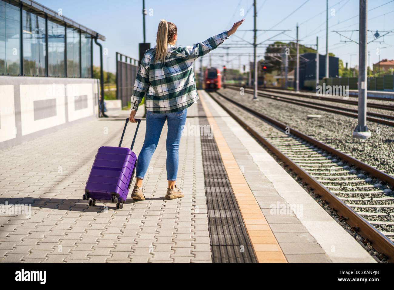Person waving train station hi-res stock photography and images - Alamy