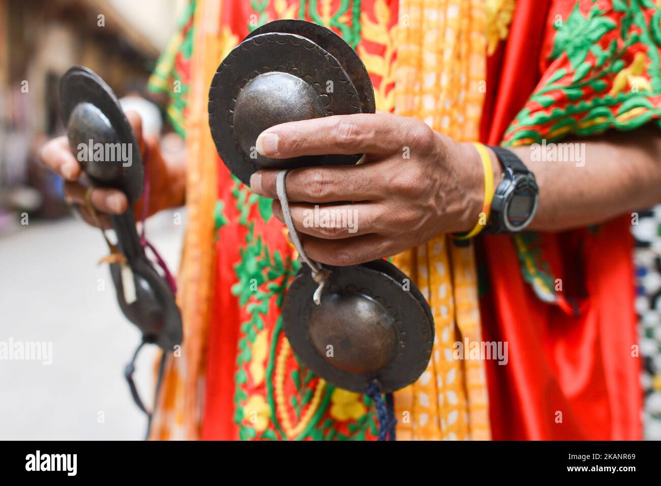 A traditional Gnawa musician using krakebs musical instrument inside ...