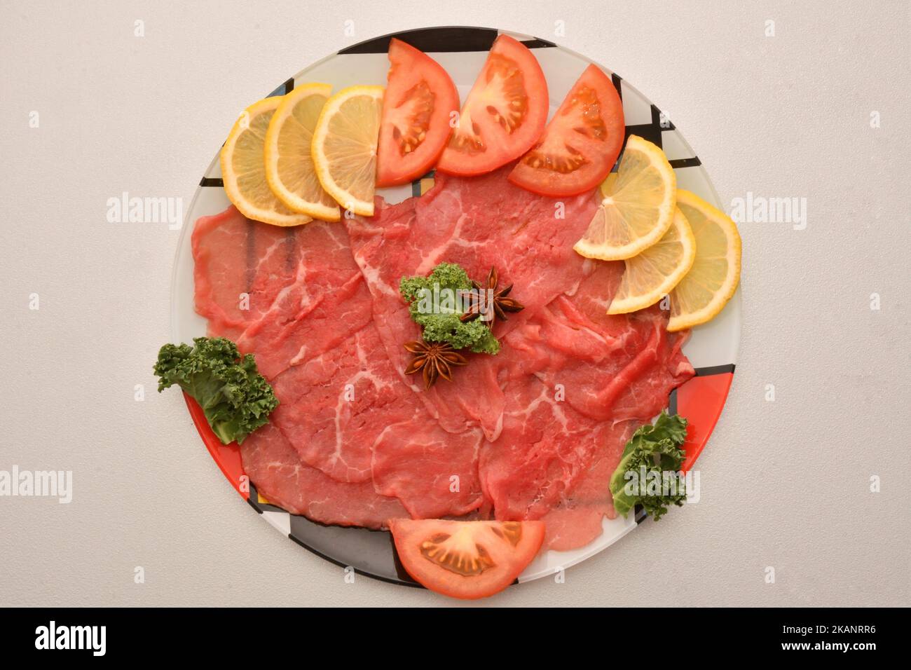 Beef carpaccio and fresh herbs for the Christmas table Stock Photo - Alamy