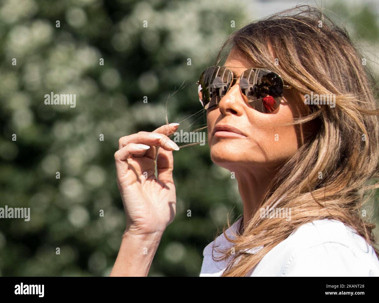 First Lady Melanie Trump, with the refletion of her 11-year-old son ...