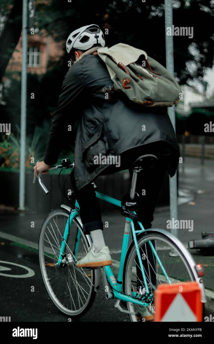 A bike rider riding home from work with his mint green bike Stock Photo ...