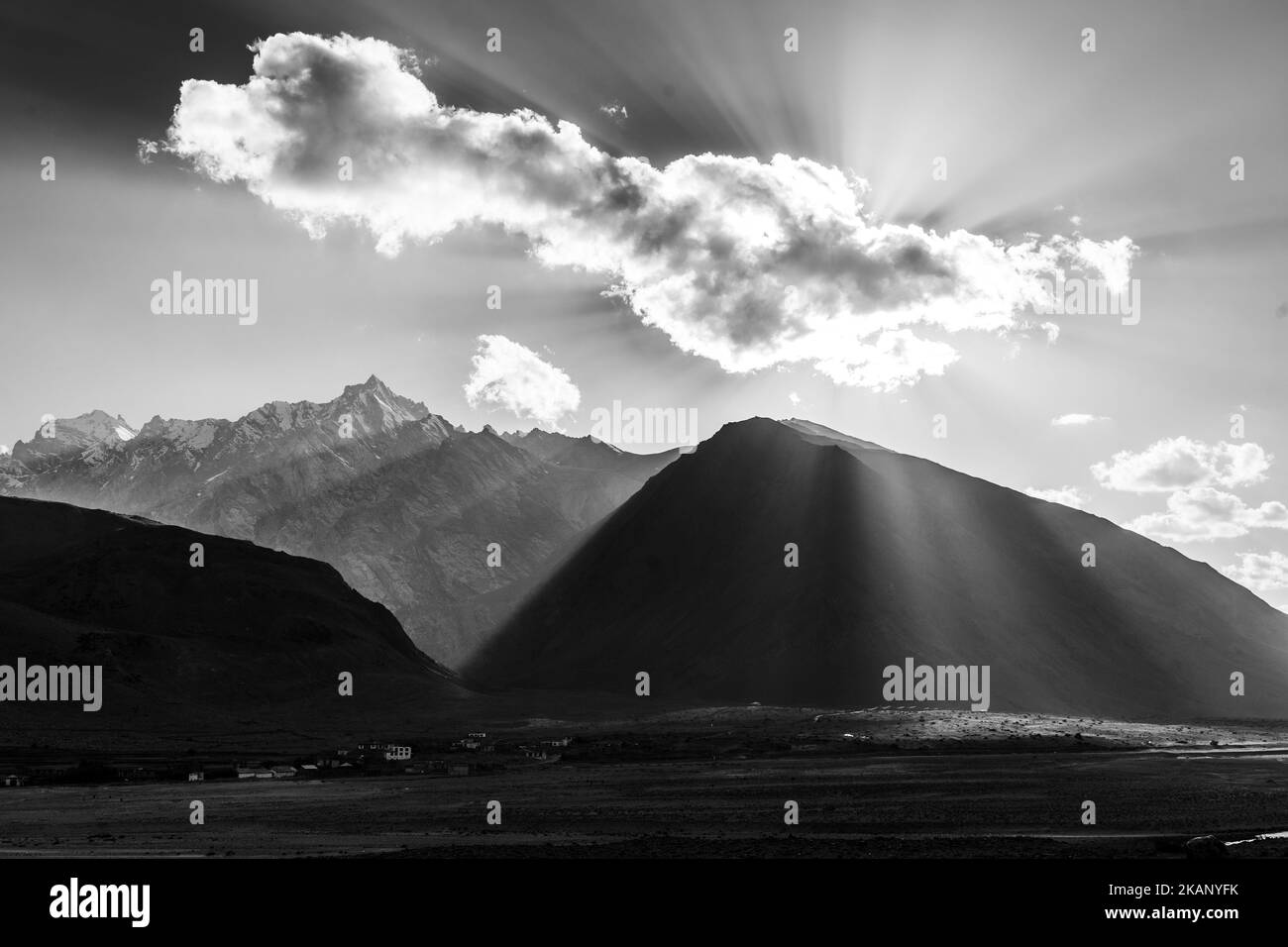 A grayscale of mountains under the sunlight Stock Photo - Alamy