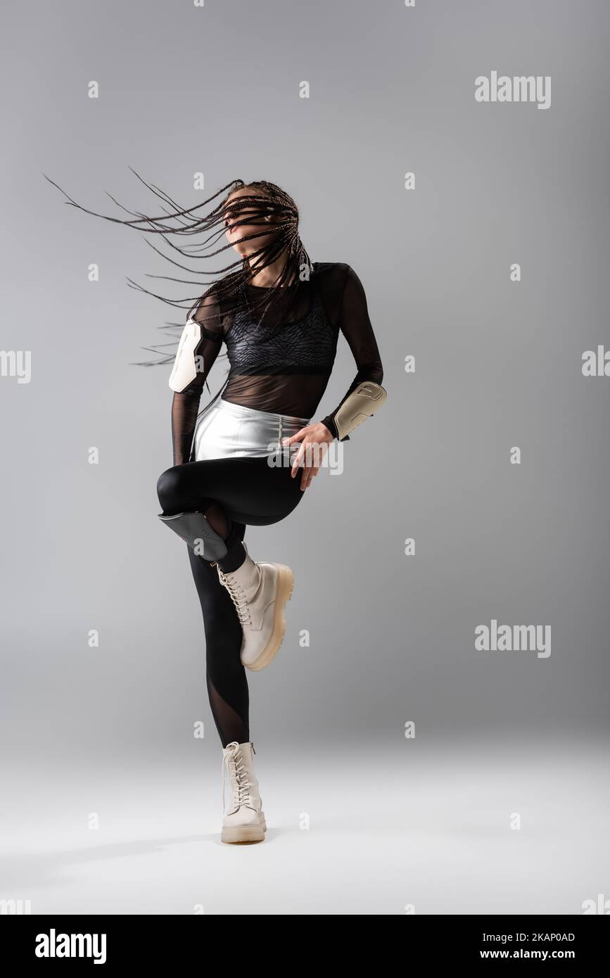 woman with braided dreadlocks posing in white boots and futuristic ...