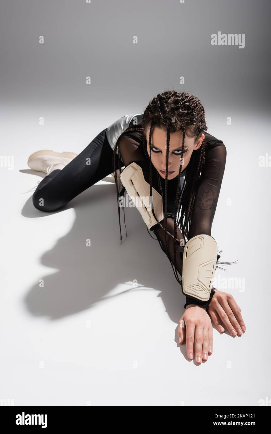 sensual woman with dreadlocks posing in futuristic style clothes on ...