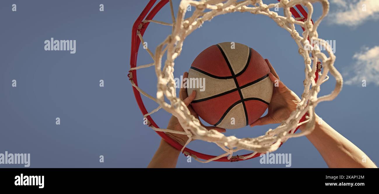 hands of basketball player throws the ball into the hoop, success ...
