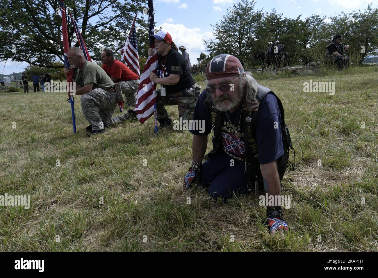 Members of patriotic groups are invited by a speaker to touch the ...