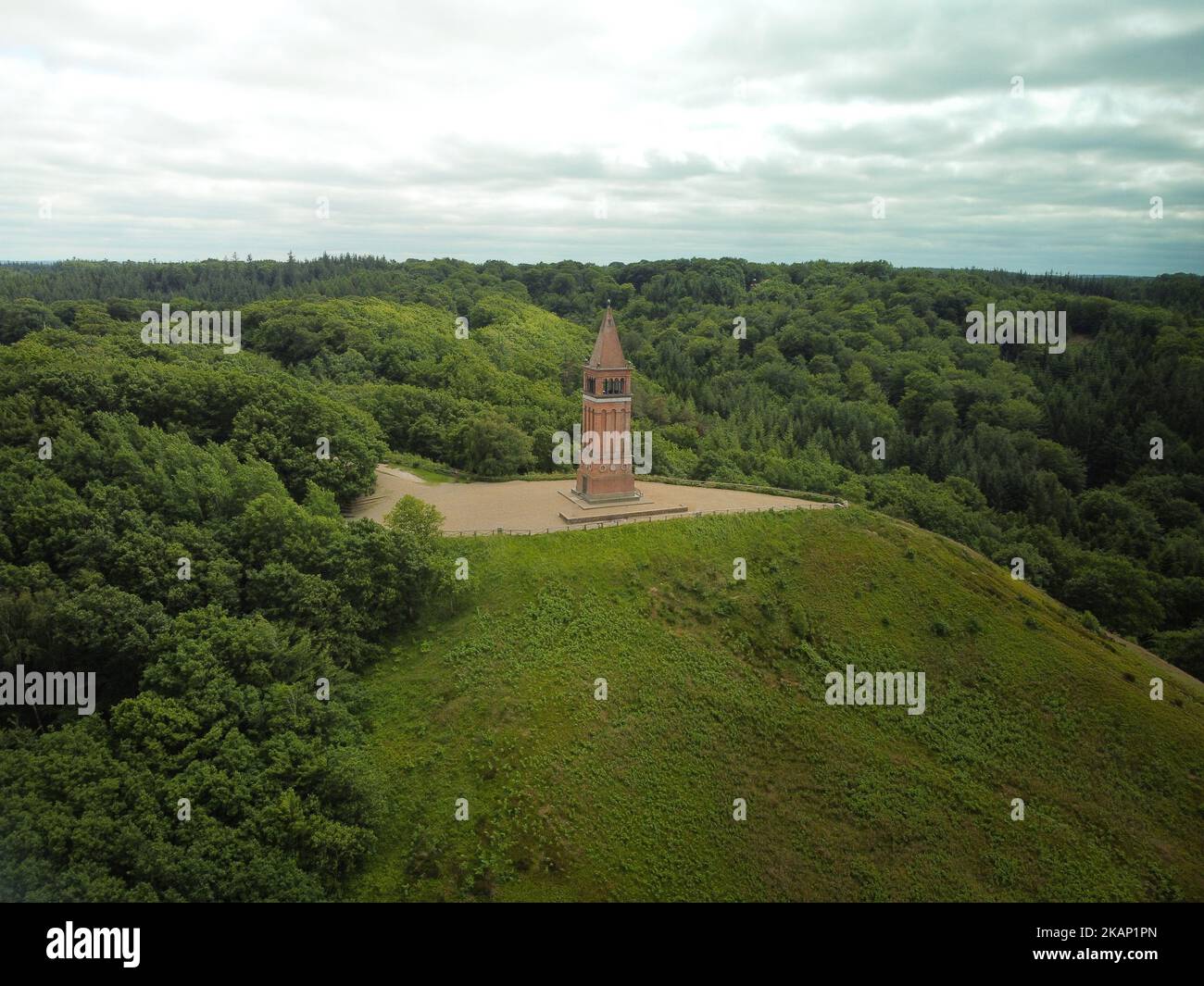 The highest sky mountain top with tower surrounded by thick forest in ...