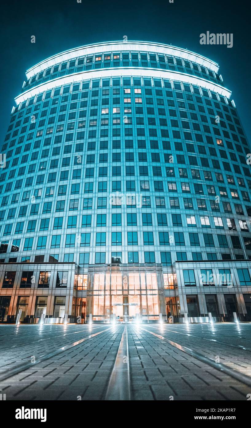 The facade of high business center building with bright neon blue ...