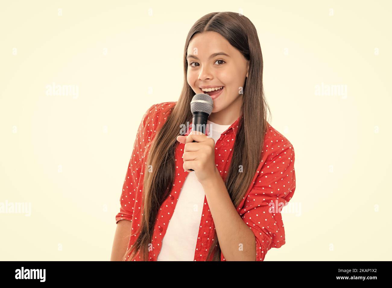 Pretty little girl singing with the microphone. Portrait of emotional ...