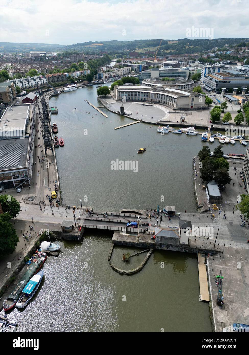An aerial view of Bristol with a bridge over the river and dense ...