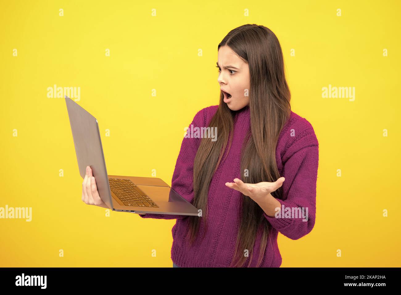 Young girl student hold computer. Funny pupil with laptop isolated on ...