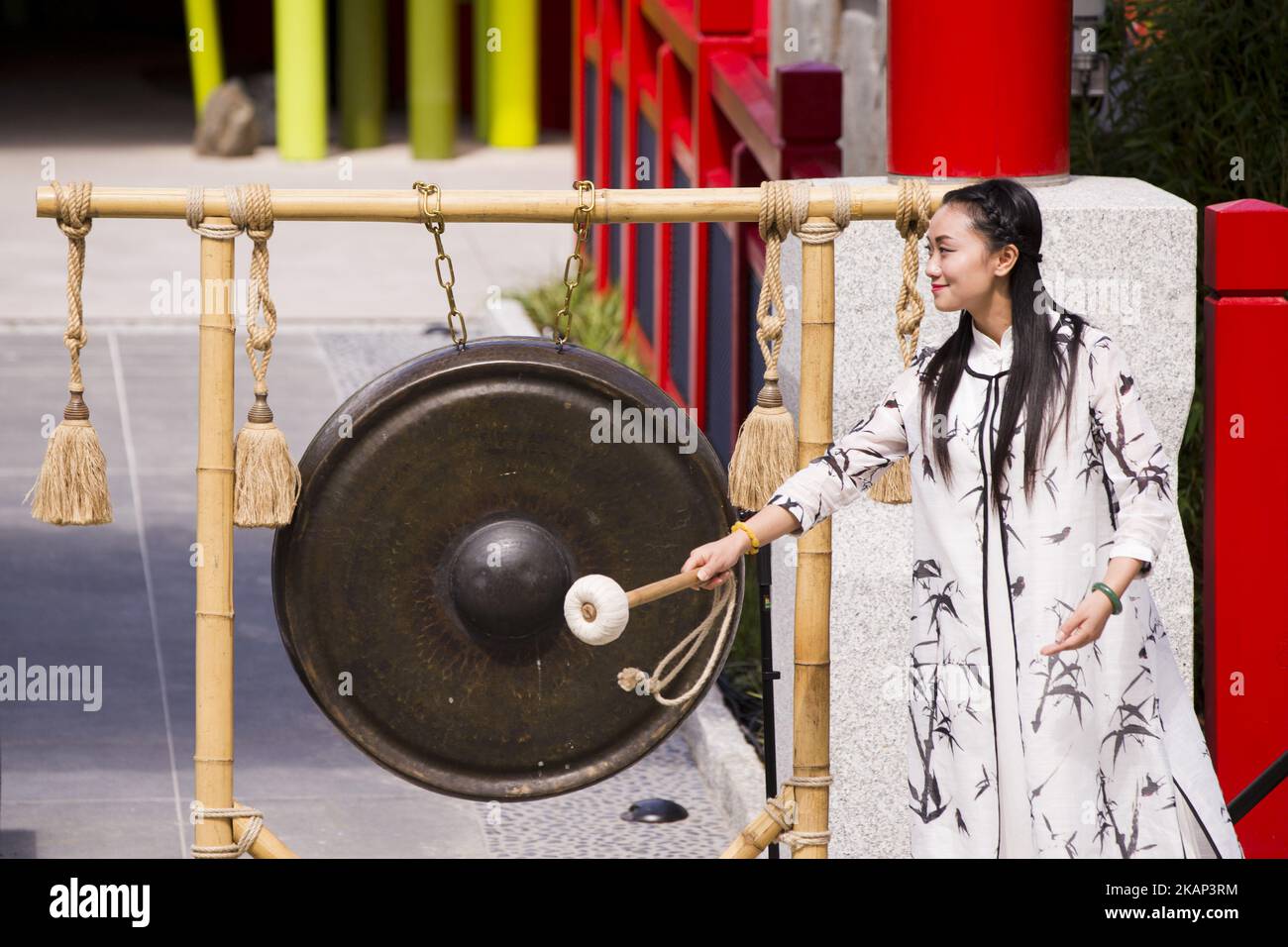 A musician plays a gong during the official welcoming ceremony for the ...