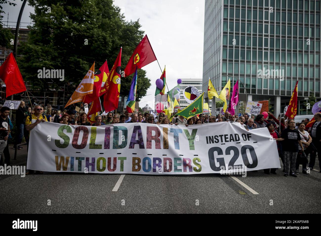 Demonstrators carry the front transparent, in Hamburg, Germany, on July 8, 2017. Under the motto ...