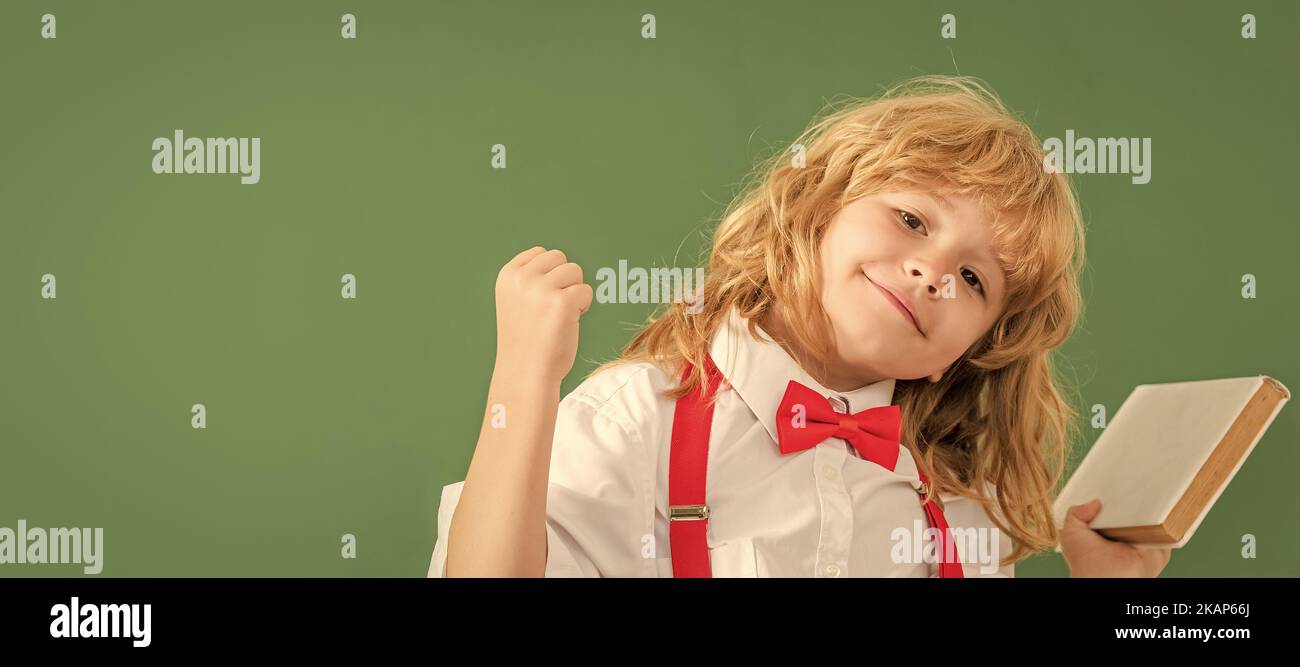 School pupil boy on blackboard, banner copy space. nerd kid with long ...