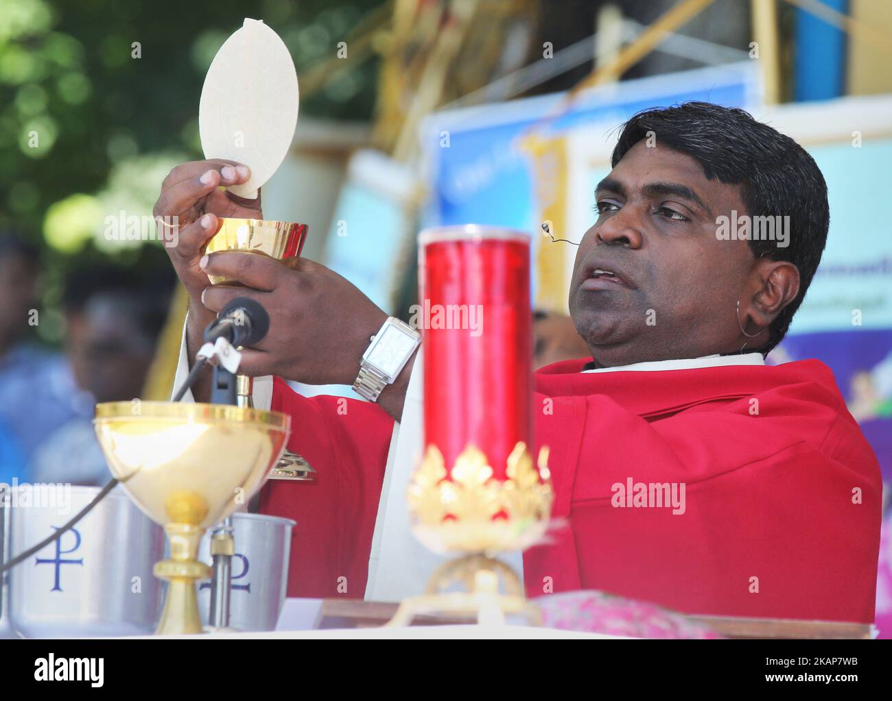 Tamil Catholic priests perform communion during the Feast of Our Lady ...