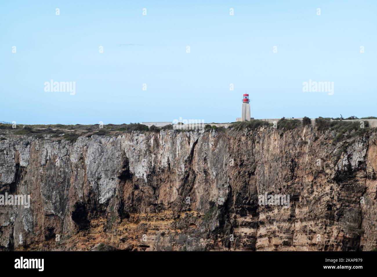 The lighthouse on Ponta de Sagres on a rocky cliff peninsula extending ...