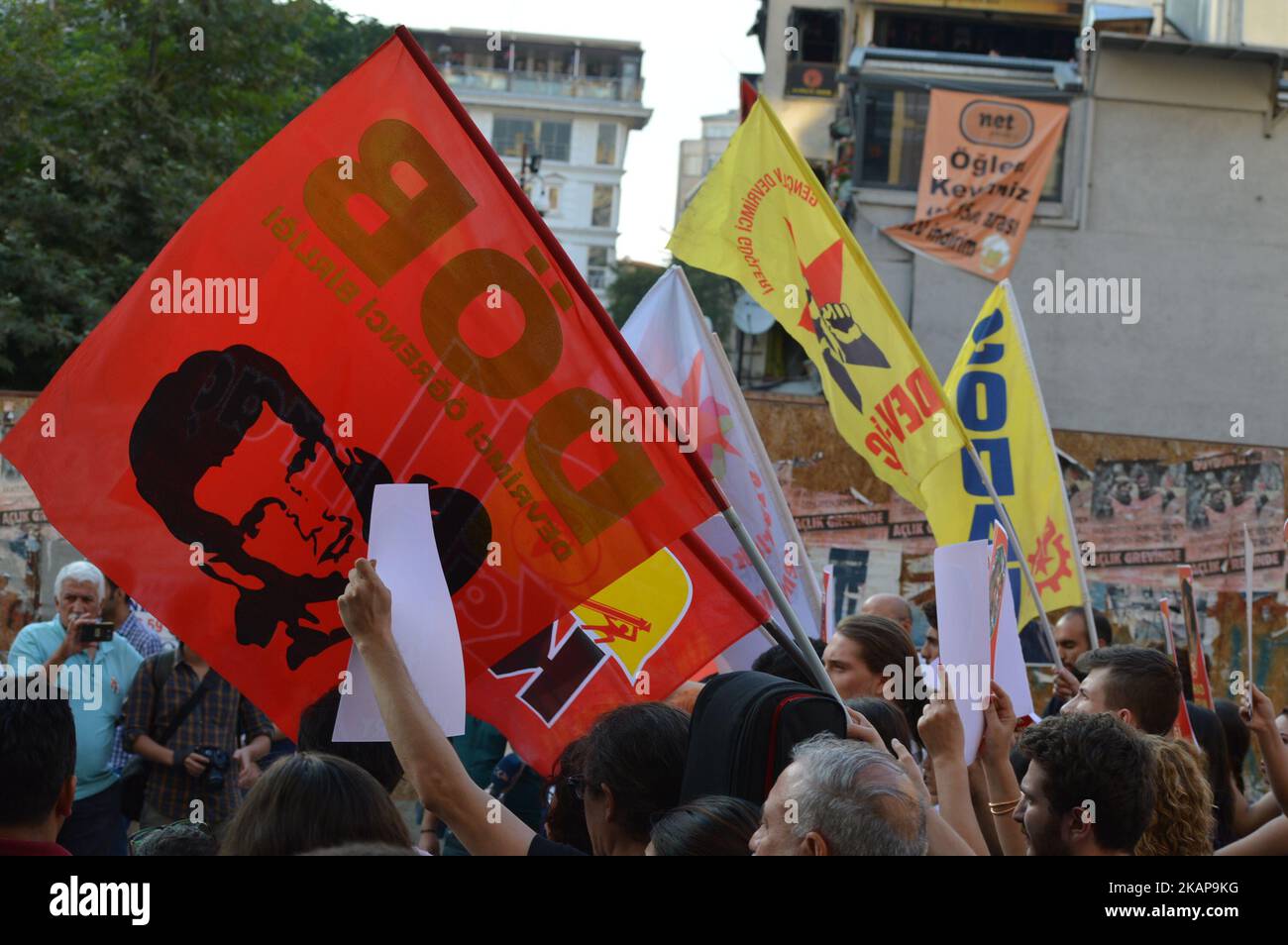 People hold flags during a commemoration to mark the 2nd anniversary of ...
