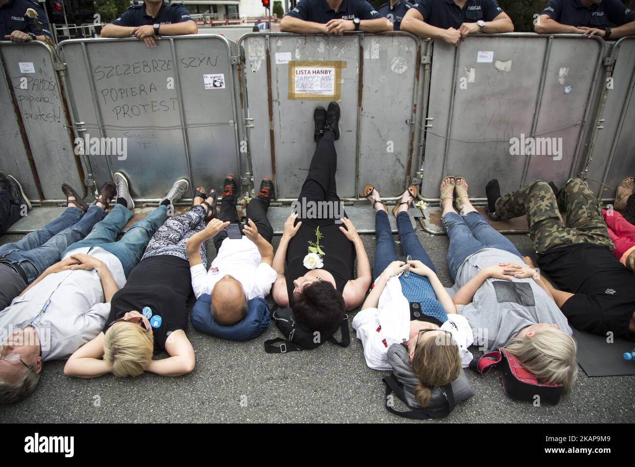 Protesters lay under barriers near polish parliament building during ...