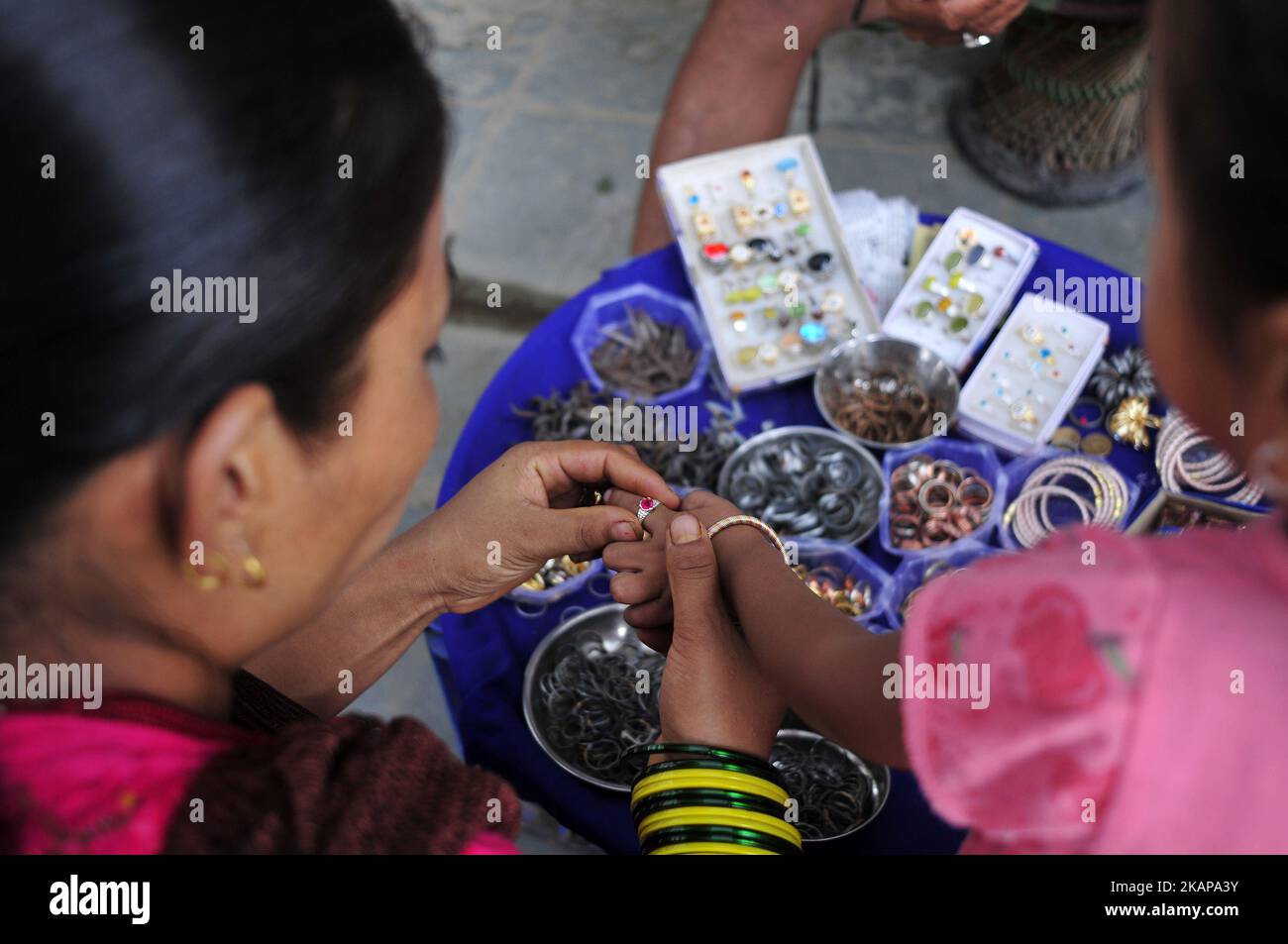A Mother select ring to her child during Gathemangal festival in ...