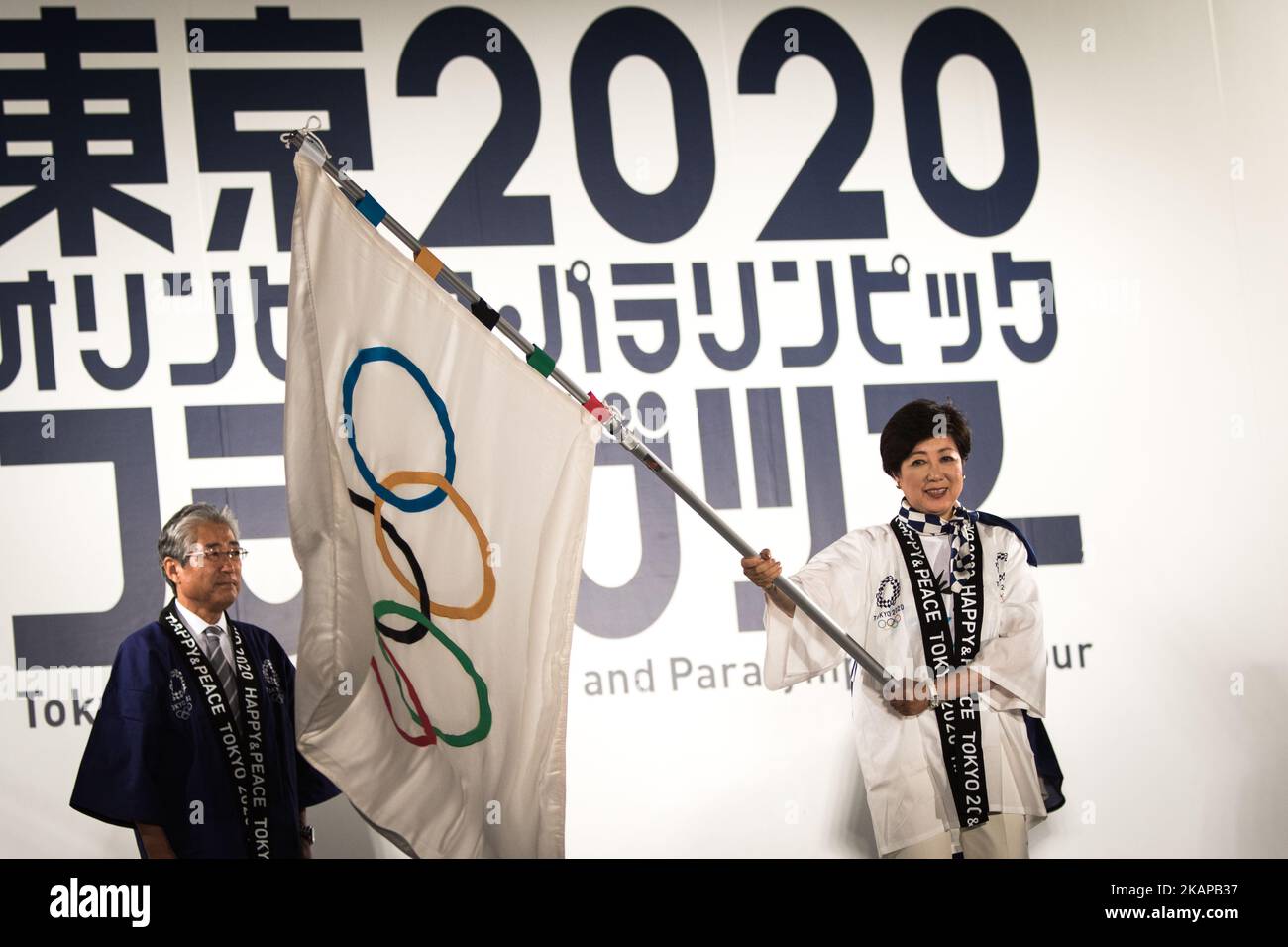 Tokyo Gov. Yuriko Koike waves an Olympic flag during the Tokyo 2020 ...