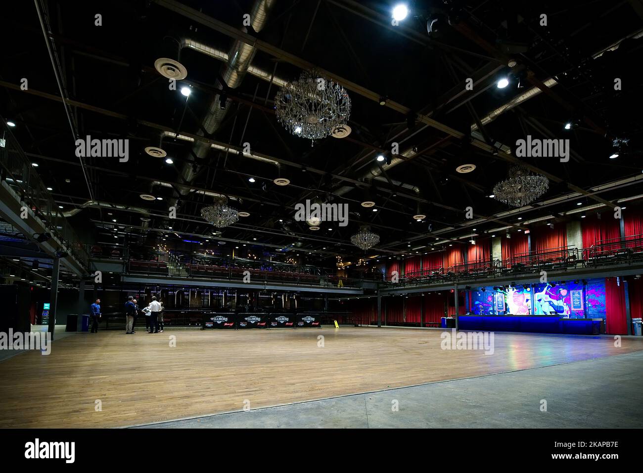 Wooden floor, red fabric and chandeliers are style elements from the ...