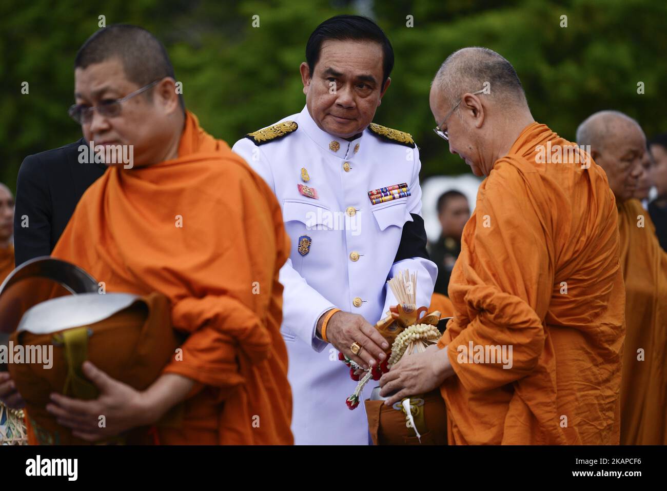 Thai Prime Minister Prayuth Chan-O-Cha gives alms to Buddhist monks to ...