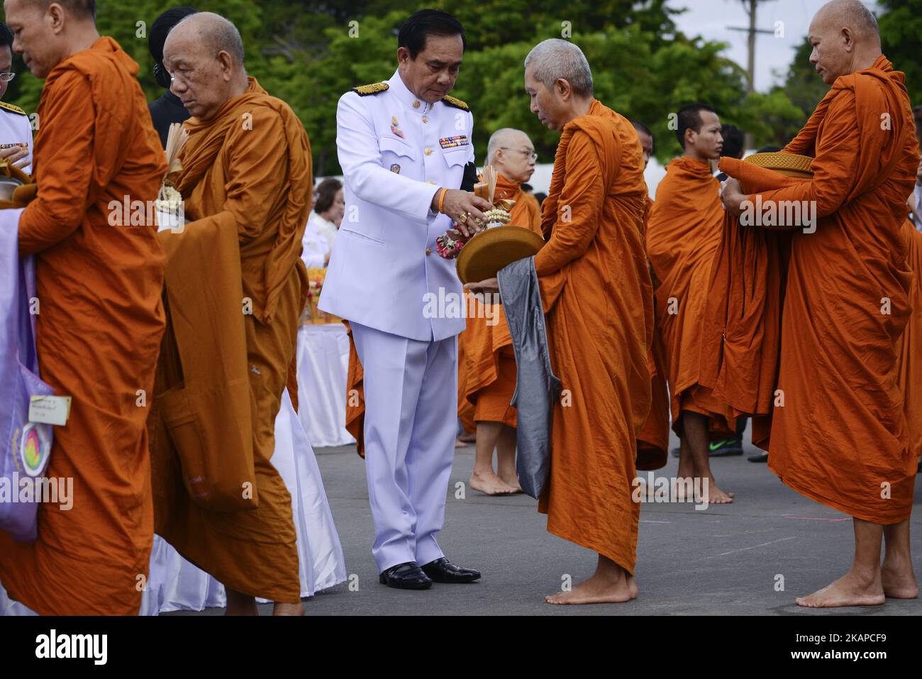 Thai Prime Minister Prayuth Chan-O-Cha gives alms to Buddhist monks to ...