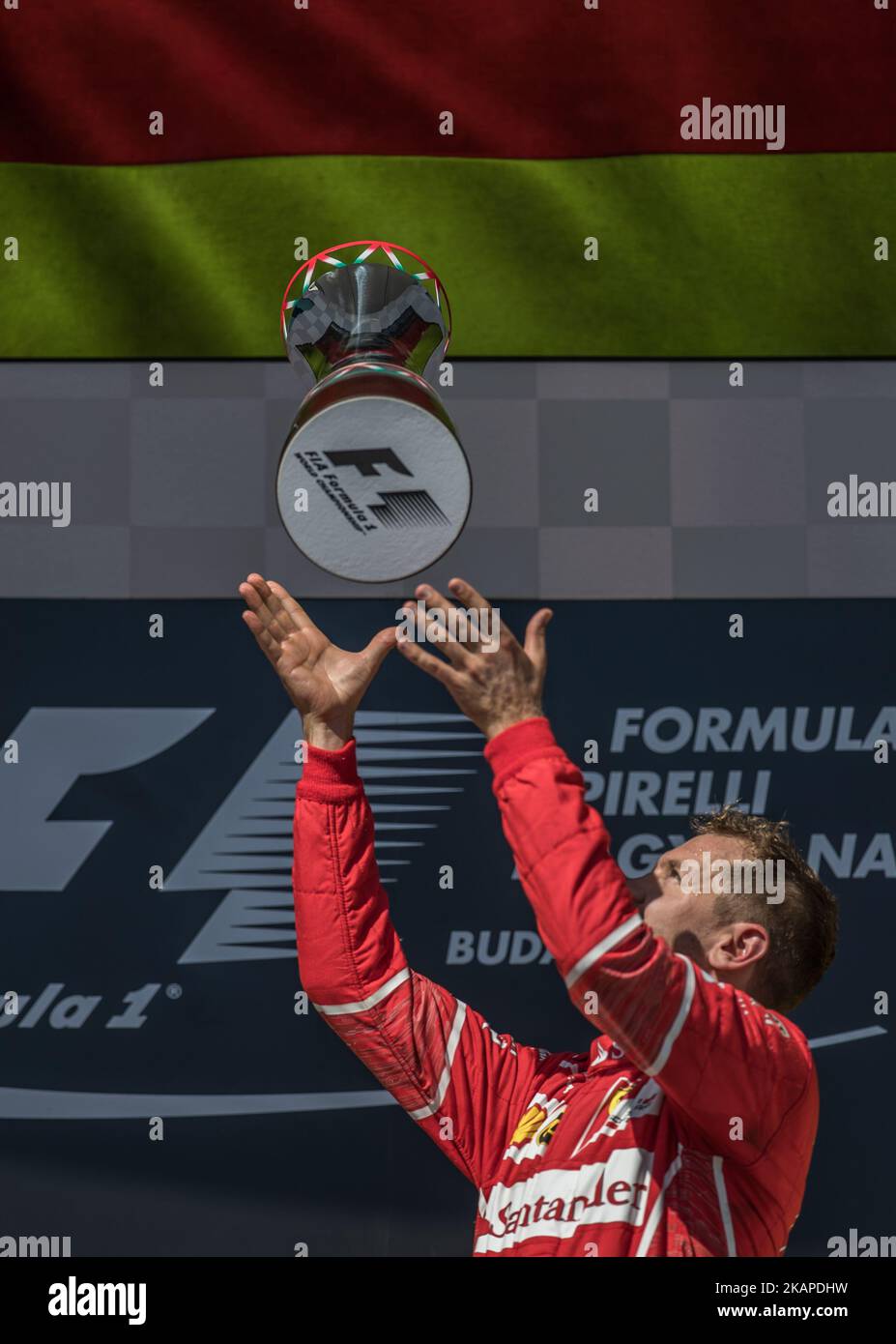 Sebastian Vettel of Germany and Scuderia Ferrari driver with the trophy ...