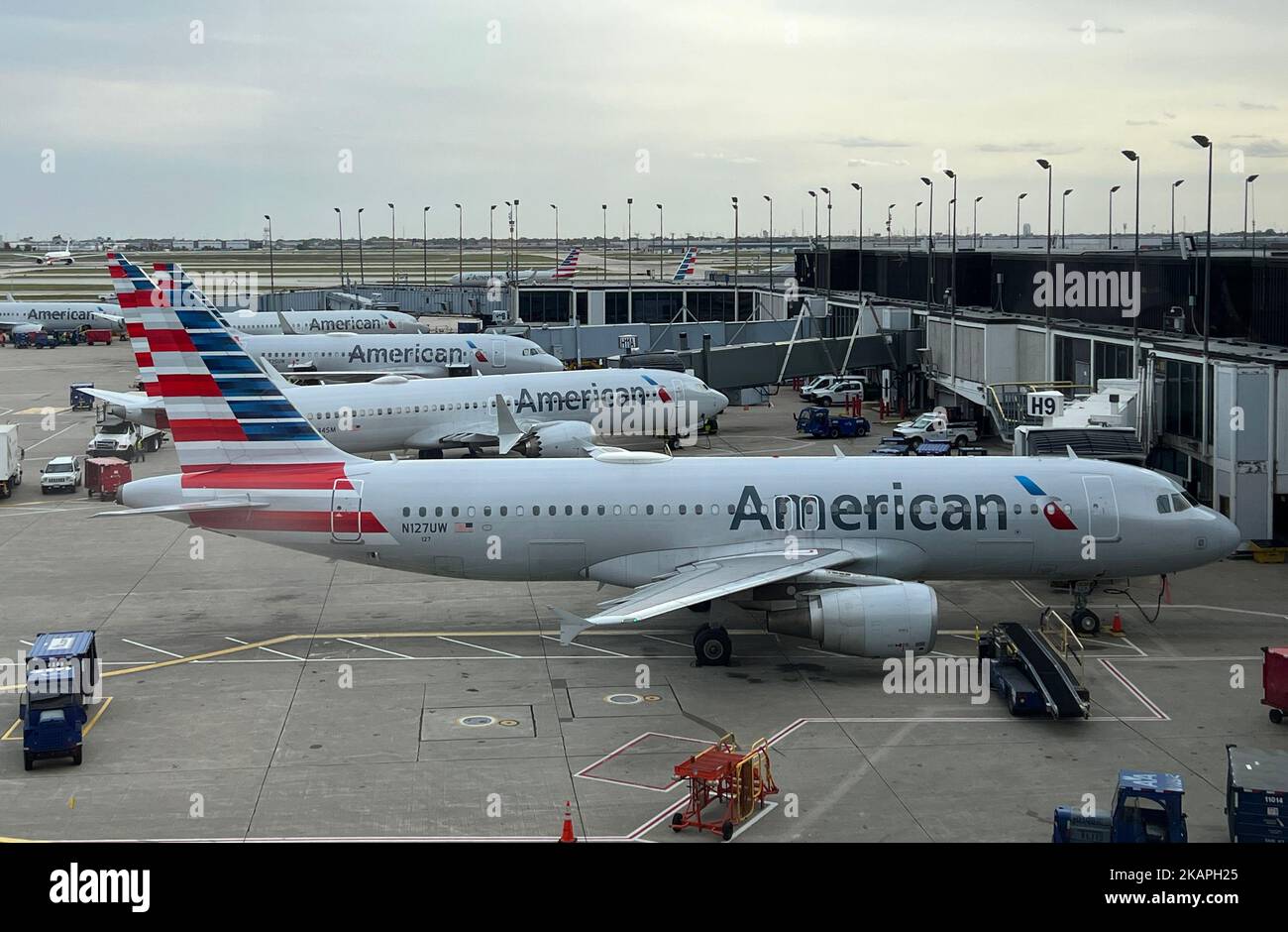 The high-angle view of American Airline planes parked at the gates of ...