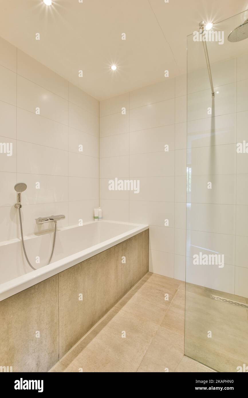 Modern home interior design of white bathroom with open bathtub from ...