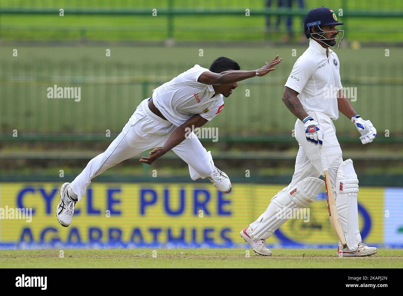 Sri Lankan cricketer Vishwa Fernando(L) delivers a ball as India's ...