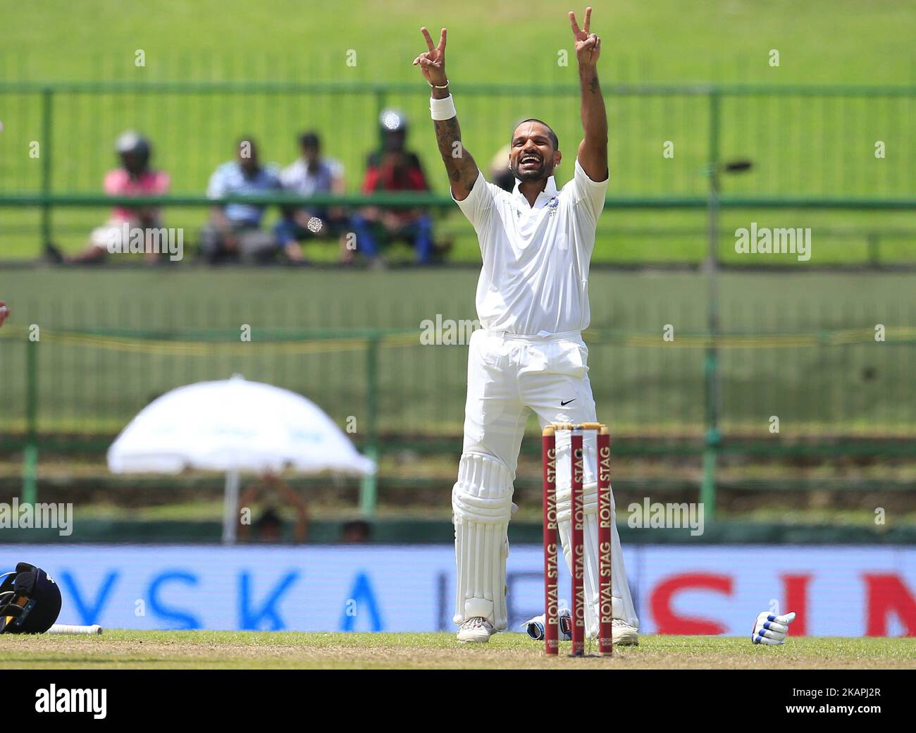 Indian cricketer Shikhar Dhawan celebrates after scoring 100 runs ...