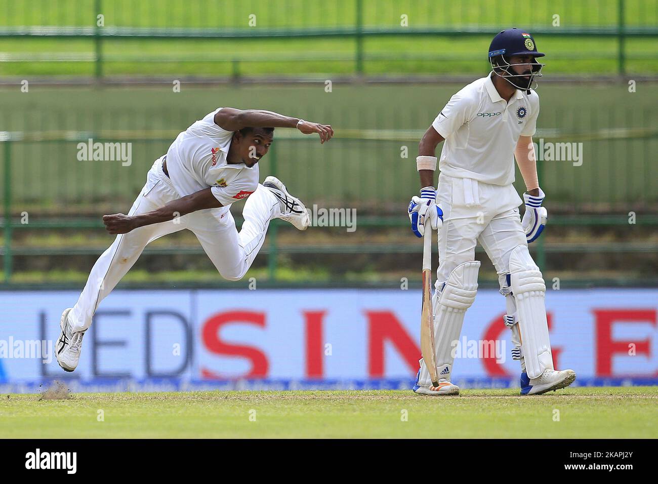 Sri Lankan cricketer Vishwa Fernando(L) delivers a ball as India's ...