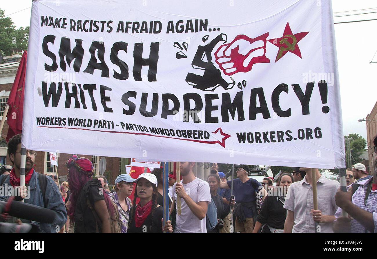 Protesters carry anti-white supremacy signs during the Unite the Right ...