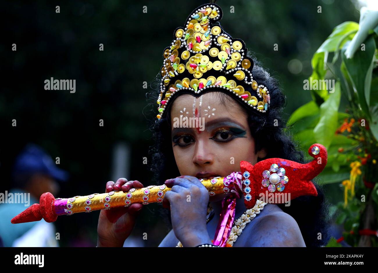 A couple poses as Sri Krishna and Radha on a peacock like float in a ...