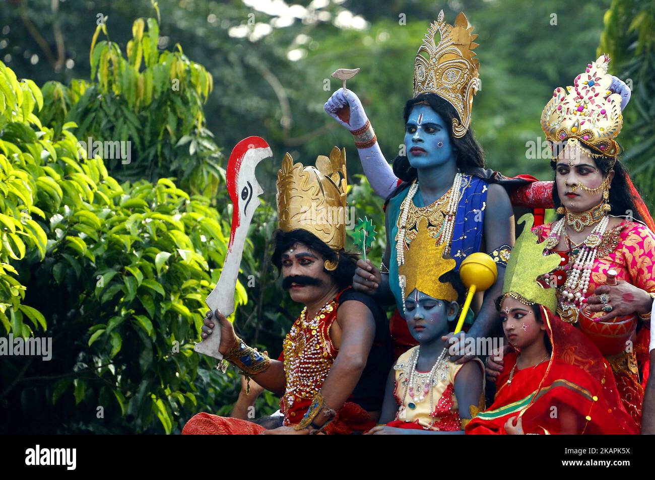 A couple poses as Sri Krishna and Radha on a peacock like float in a ...