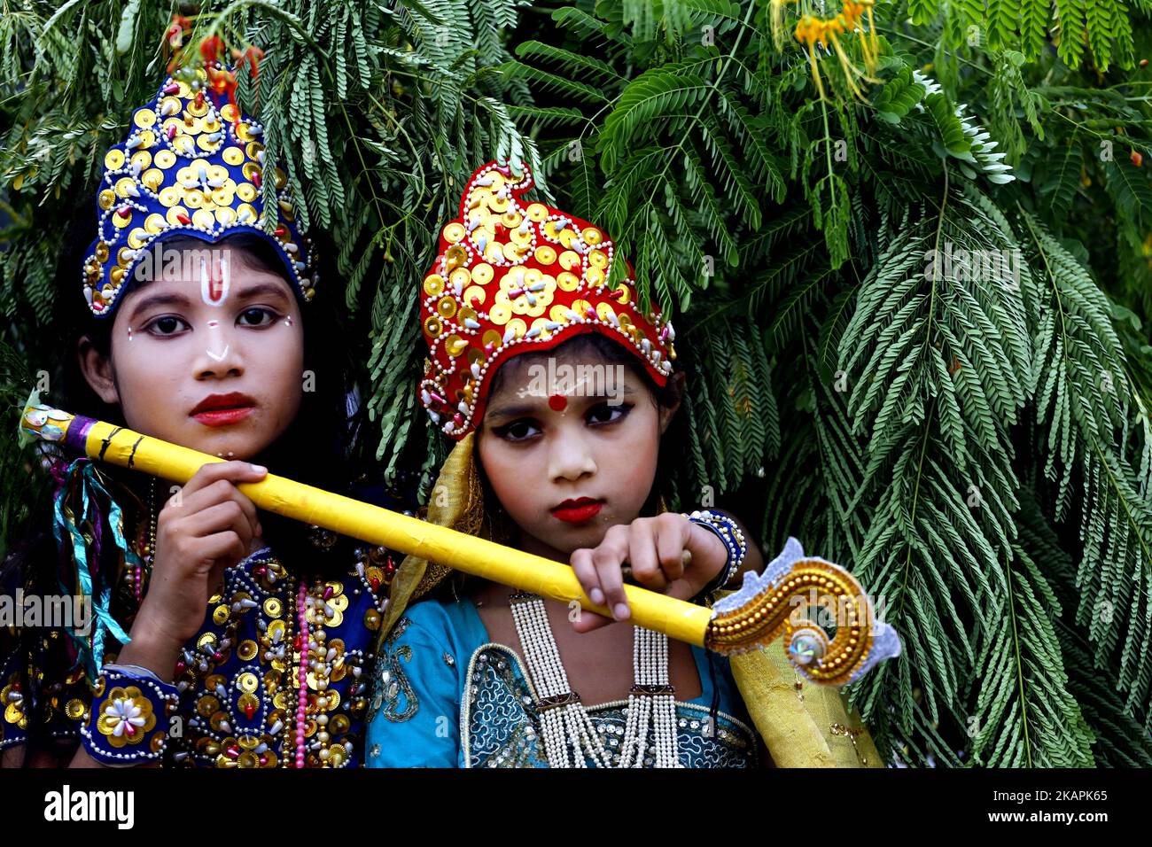 A couple poses as Sri Krishna and Radha on a peacock like float in a ...