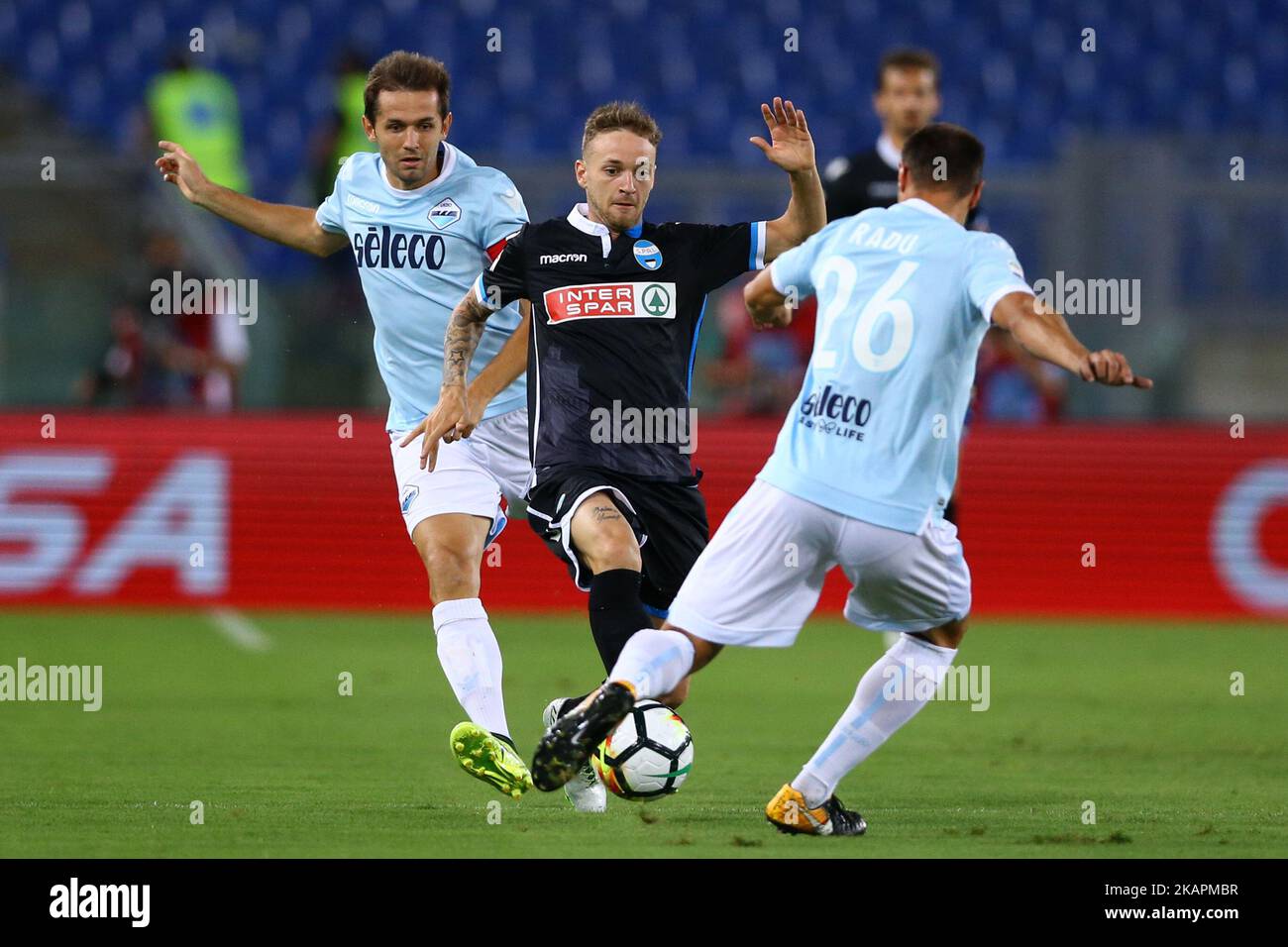 Manuel Lazzari of Spal between Senad Lulic of Lazio and ?tefan Radu of ...