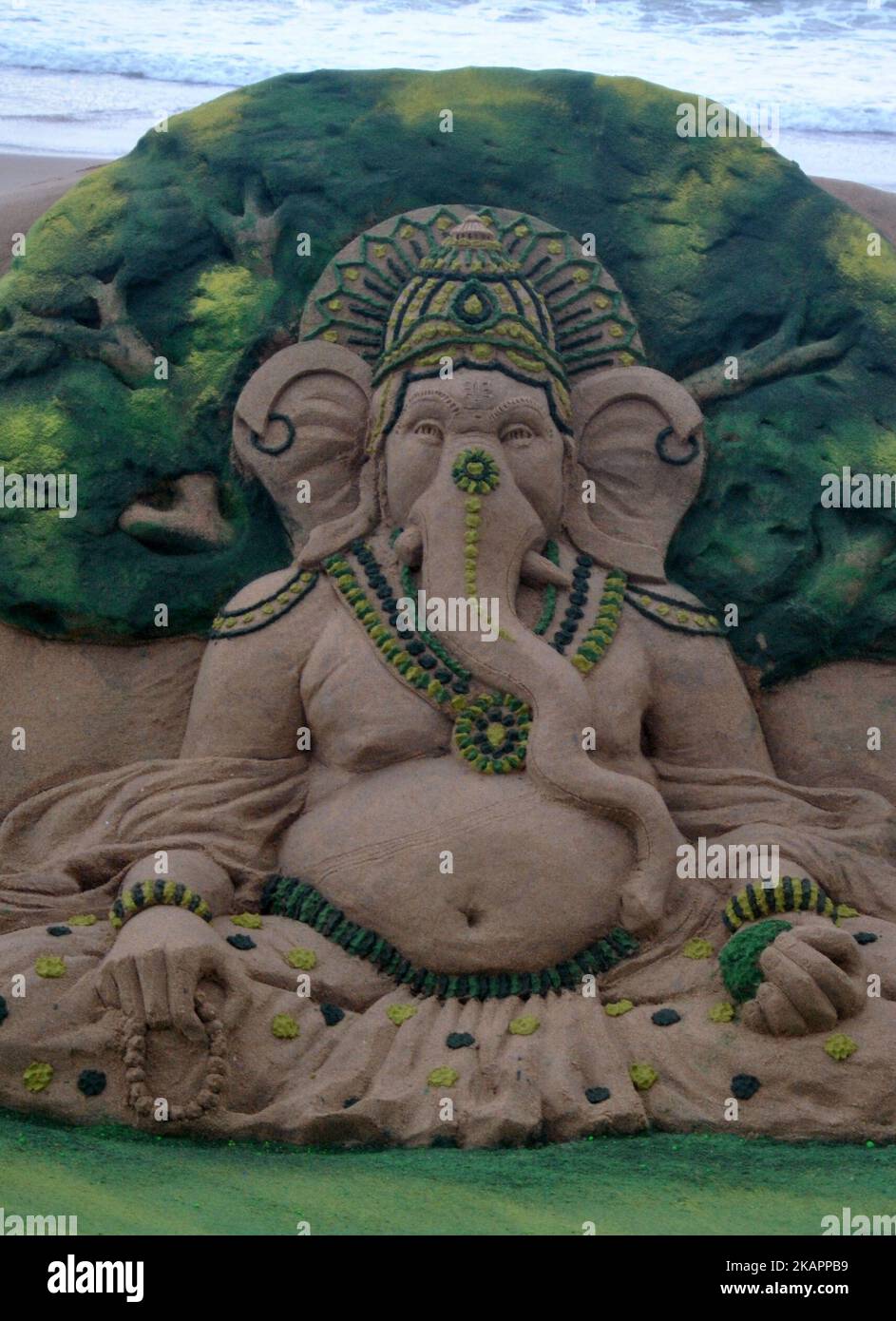 Lord Ganesha's sand sculpture looks at the Bay of Bengal Sea's eastern ...