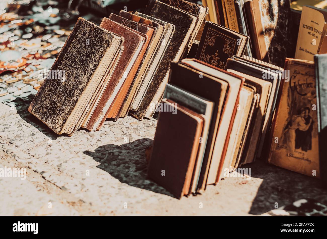 Old books are stacked in rows. Sale of vintage books. Side view Stock ...
