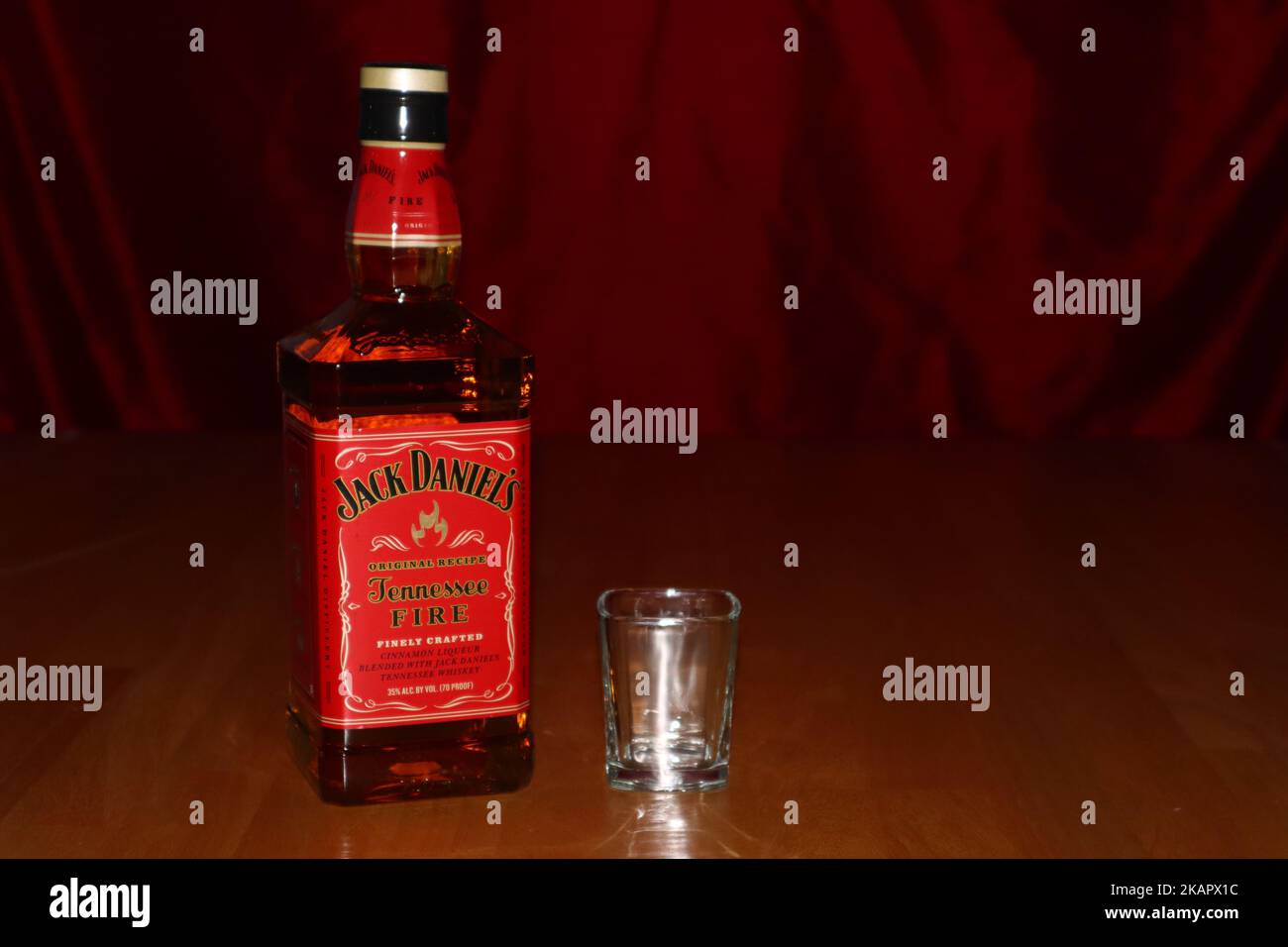 A Jack Daniel's Tennessee Fire Whiskey with a shot glass on a wooden ...