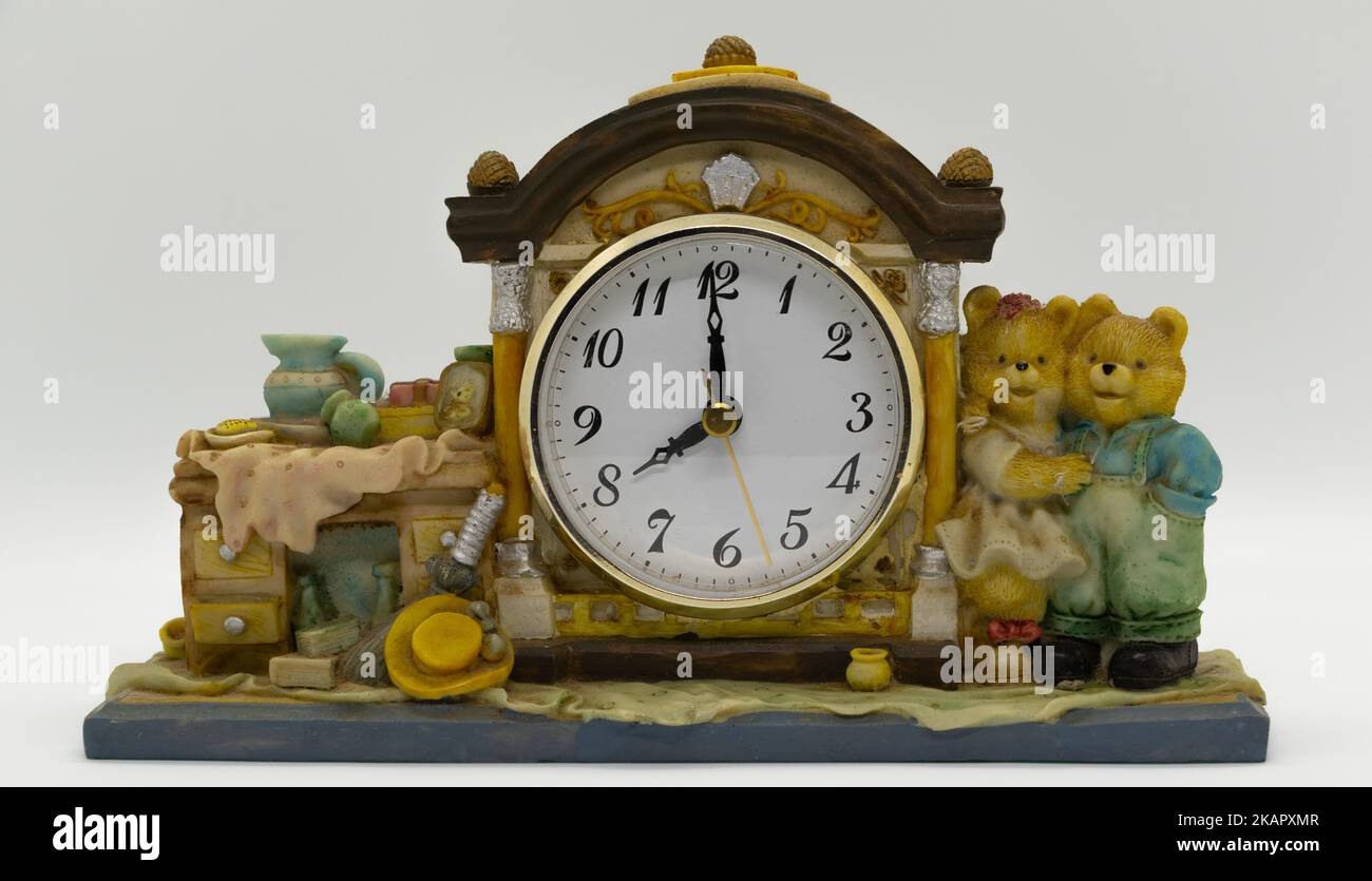 A table clock in an antique style with molded animation around on a ...