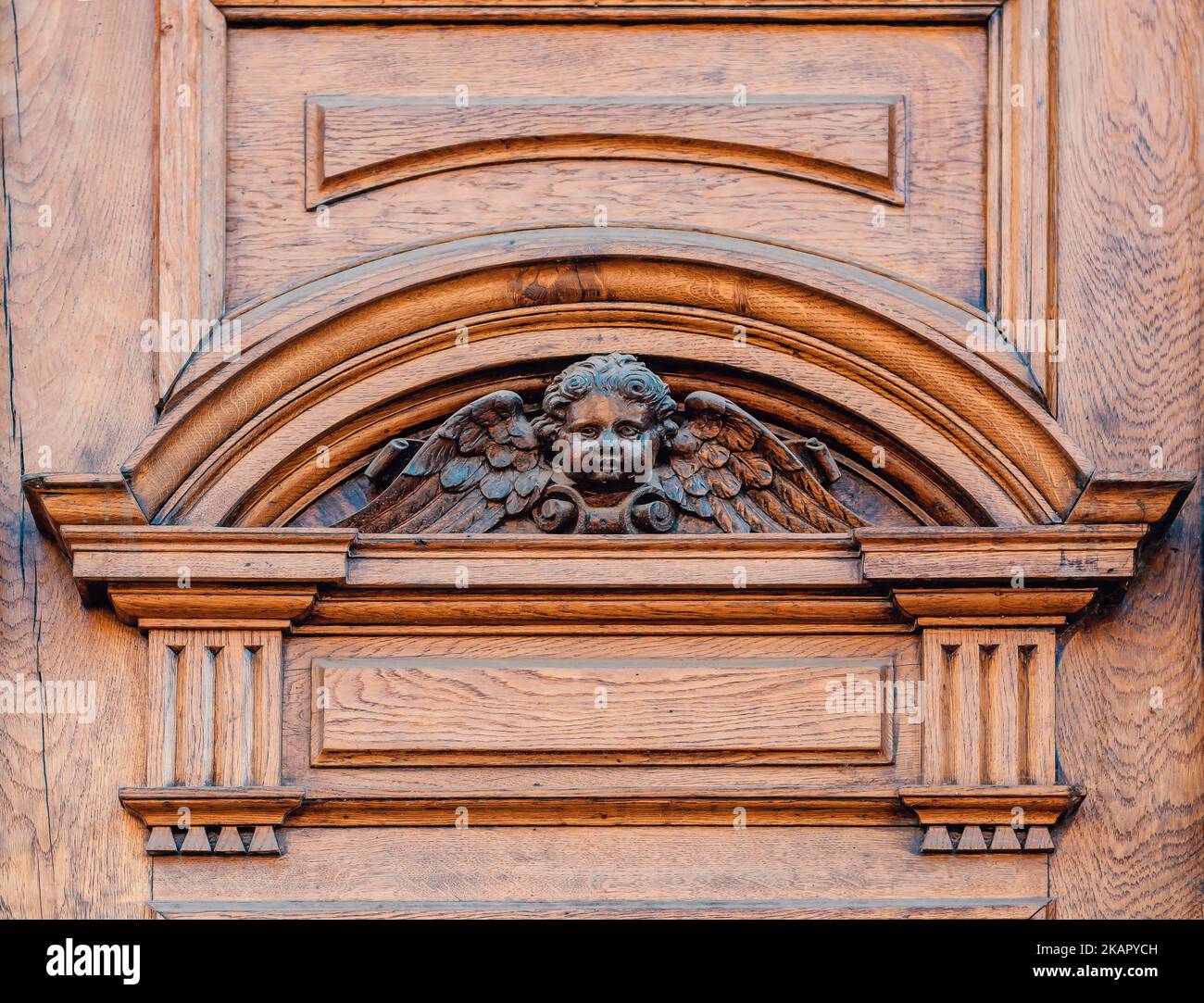 Carved angel on wooden door. Part of wooden antique doors decorated ...