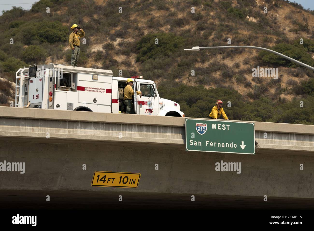 Firefighters monitor the La Tuna Canyon fire in Los Angeles, California ...