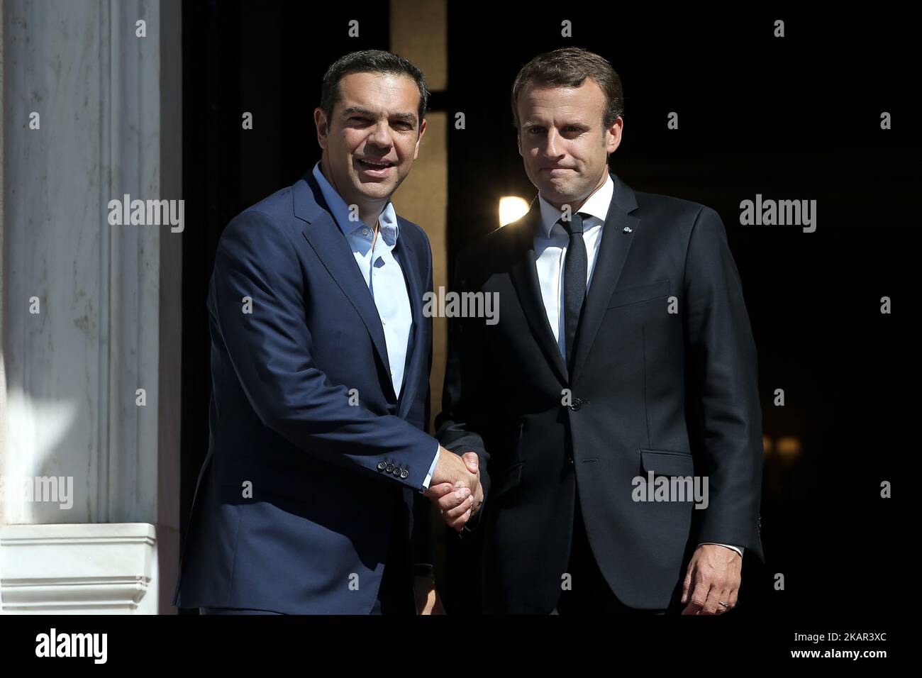 Greek PM Alexis Tsipras (L) welcomes French President Emmanuel Macron ...