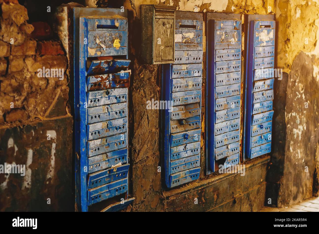 Broken vintage rusty mailboxes. View of old mailboxes hanging on dirty ...