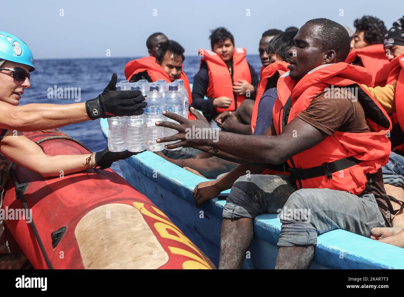 Handing out drinking water hi-res stock photography and images - Alamy