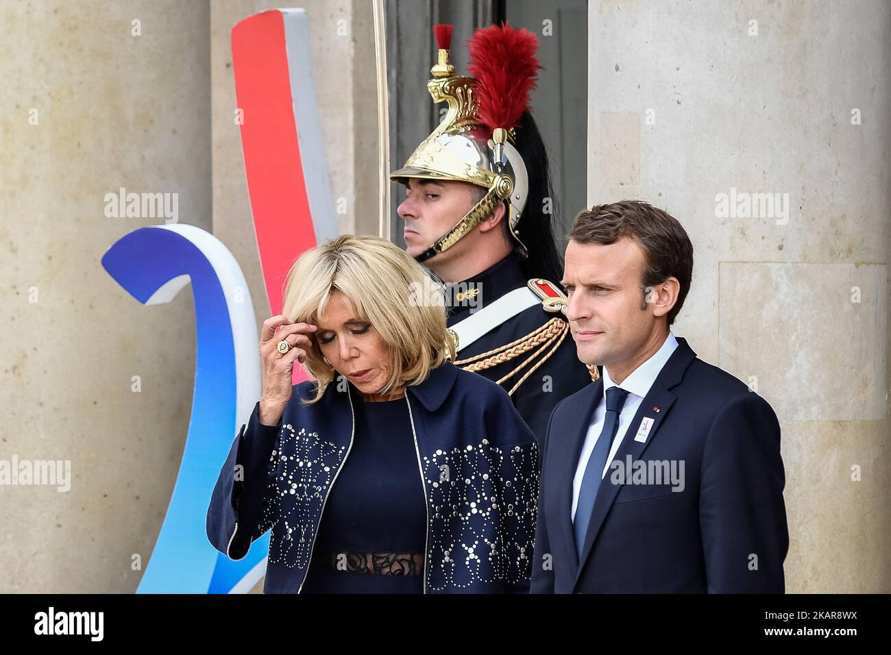 French President Emmanuel Macron (R) and his wife Brigitte Trogneux (L ...