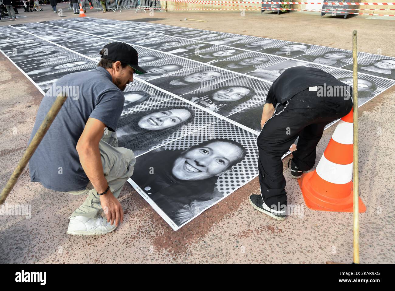 The street artist JR performing the Inside Out Project at the Mairie d ...